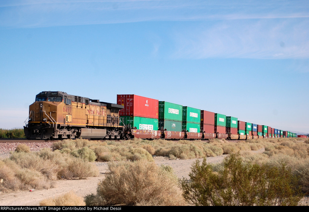 UP AC-4400CW #6497 is a single DPU on an eastbound stack train next to old Route 66